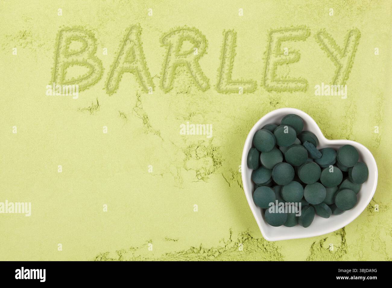 Green food supplement. Word barley written in green ground powder, top ...