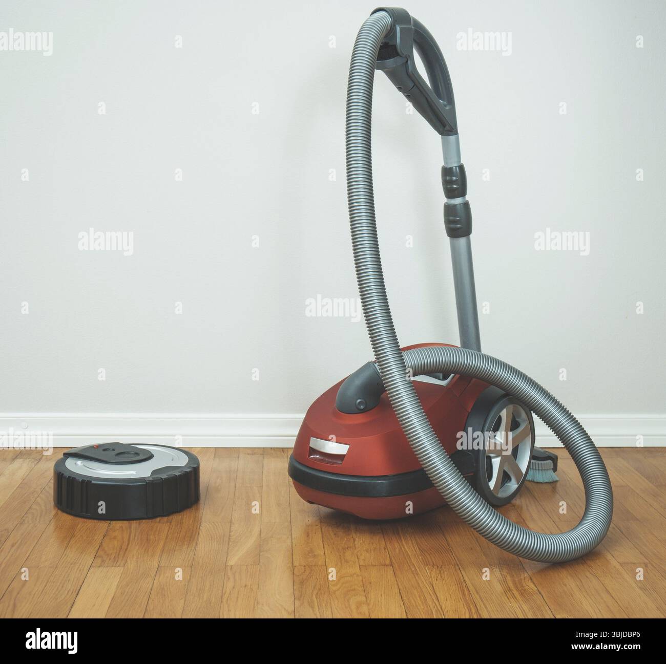 Robotic vacuum cleaner vs Vacuum cleaner Stock Photo - Alamy