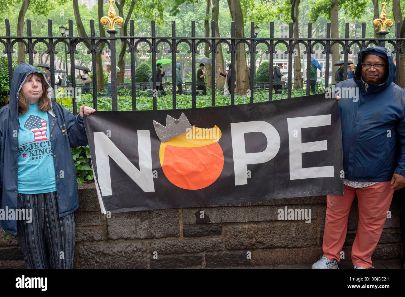 Protesters hold a "NOPE" banner as thousands of people march in the "No ...