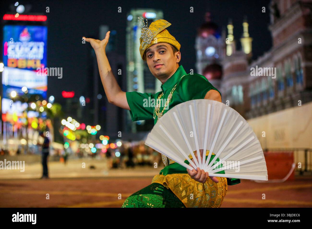 A Malay heritage dancer posses with his traditional garment during the ...