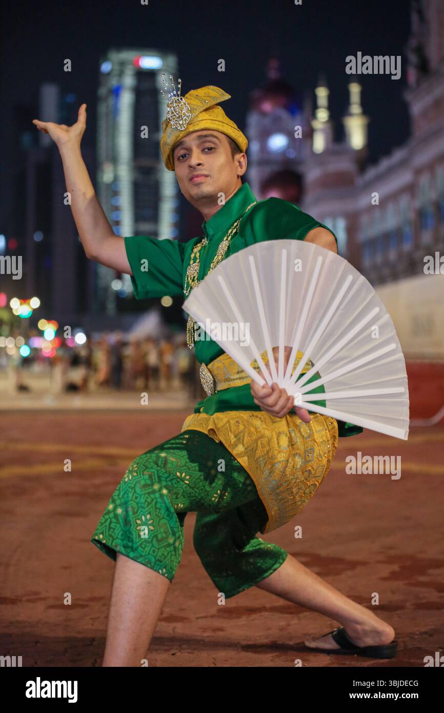 A Malay heritage dancer posses with his traditional garment during the ...
