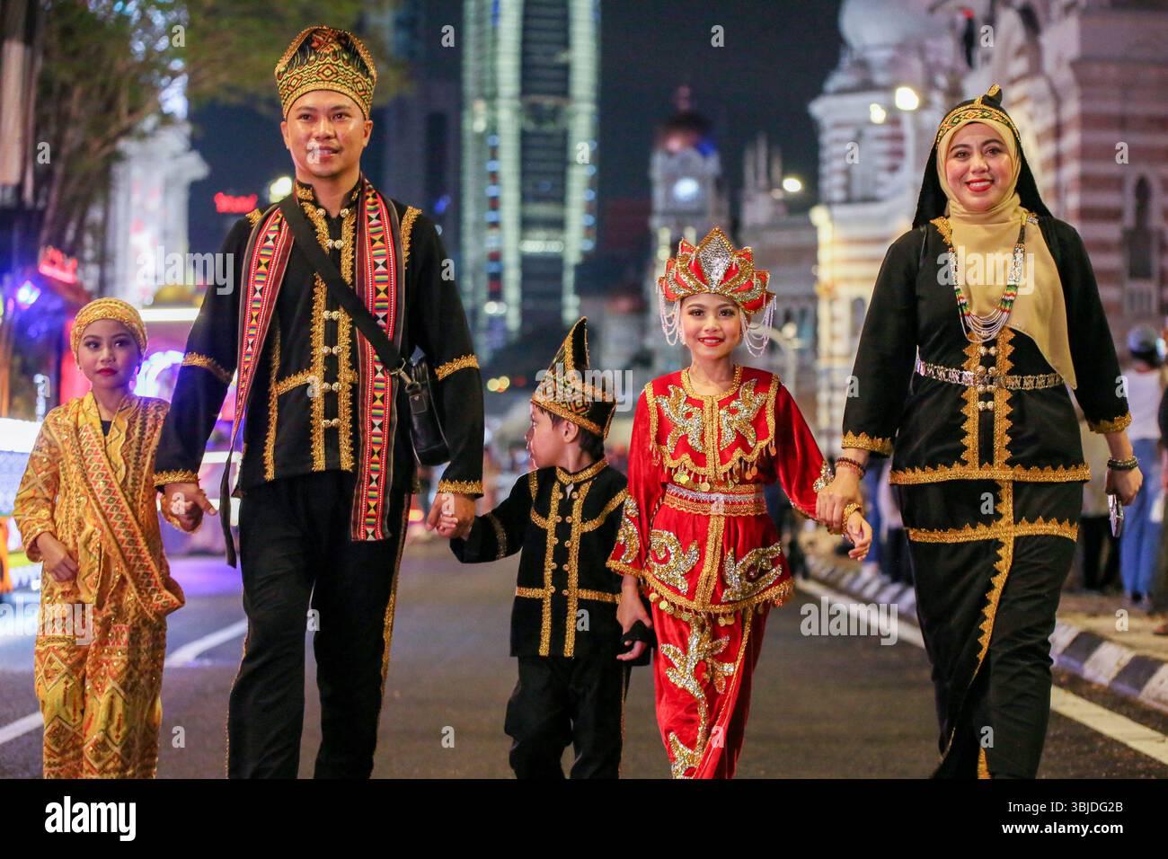A family seen wearing the Kadazan and Sabahan ethnic traditional ...