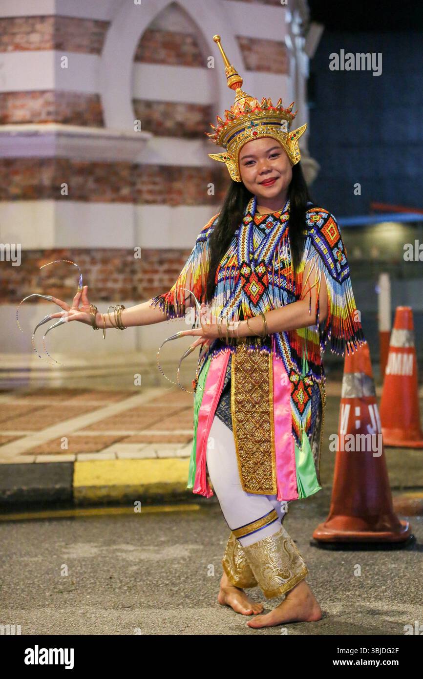 A Siamese dancer wears traditional dress during the event. The ...