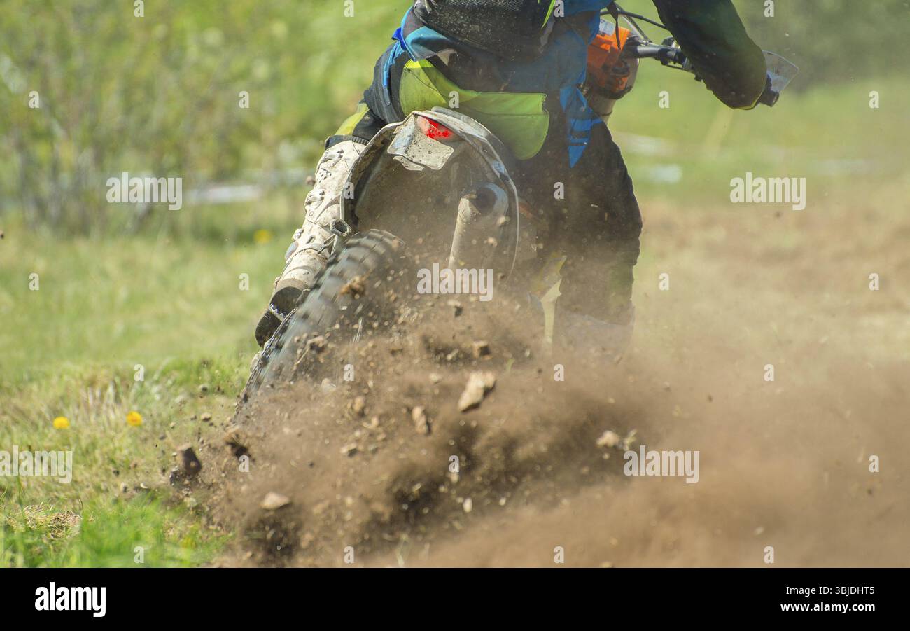 Professional motocross rider on the road. Back view Stock Photo - Alamy