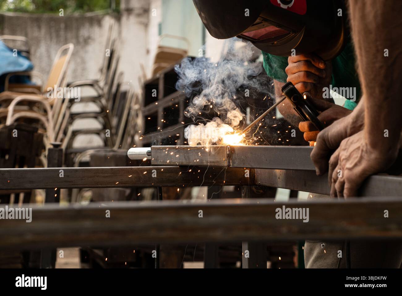 Welding metal parts with sparks and smoke - the work process of a ...