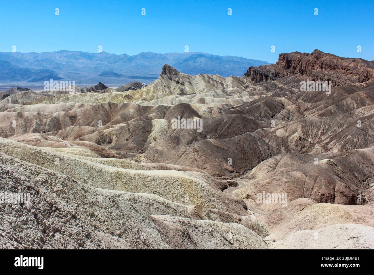 Vast, colorful hills and ridges stretch across the desert, showcasing ...