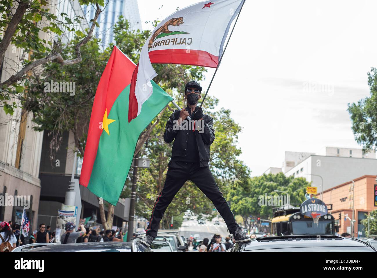 Los Angeles, California, USA. 13th June, 2025. Standing on cars, a ...