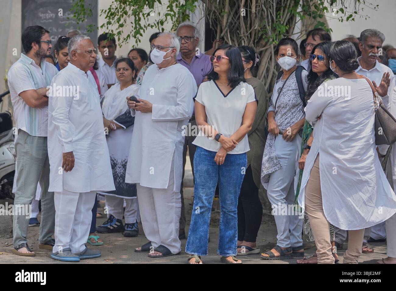 Relatives of Megha Mehta, a victim of the Air India plane crash, wait ...