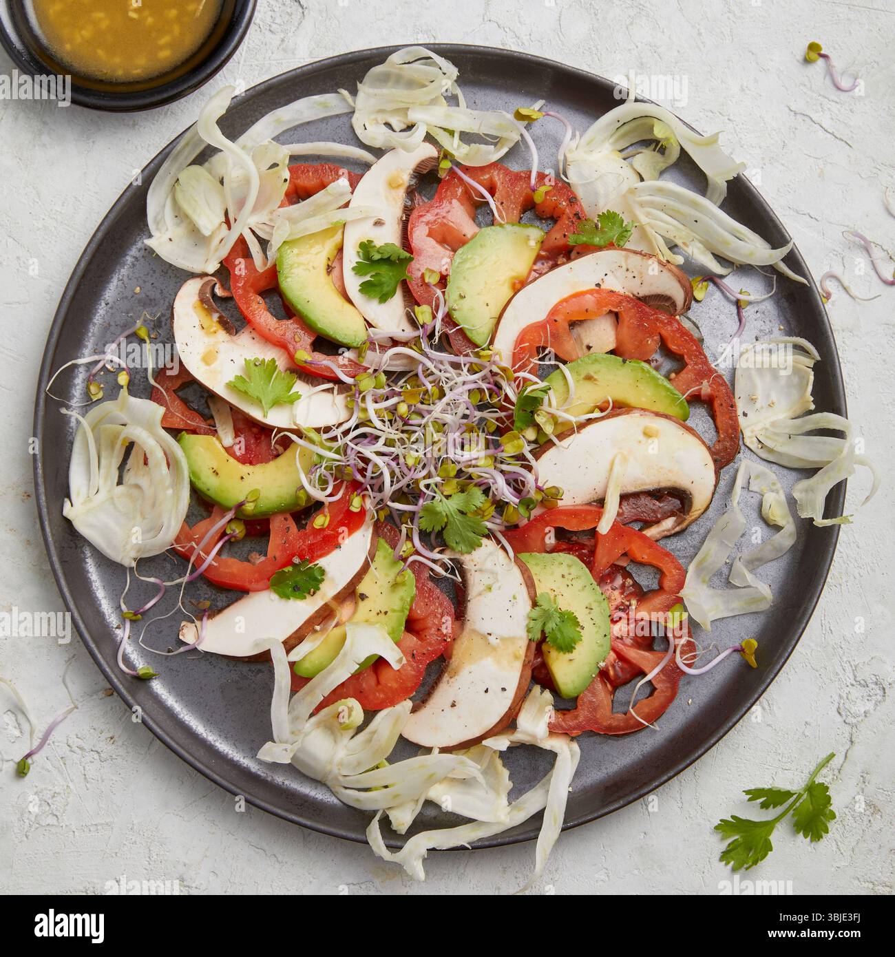 Mushroom carpaccio with avocado on grey plate – a light, fresh ...