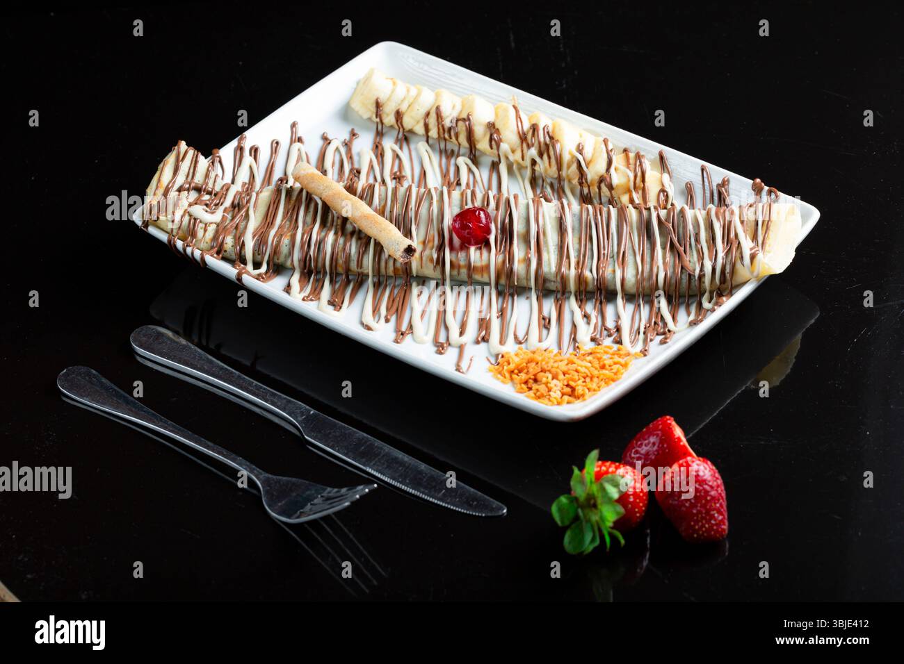 Luxury chocolate crepe on a black background, filled with melted ...