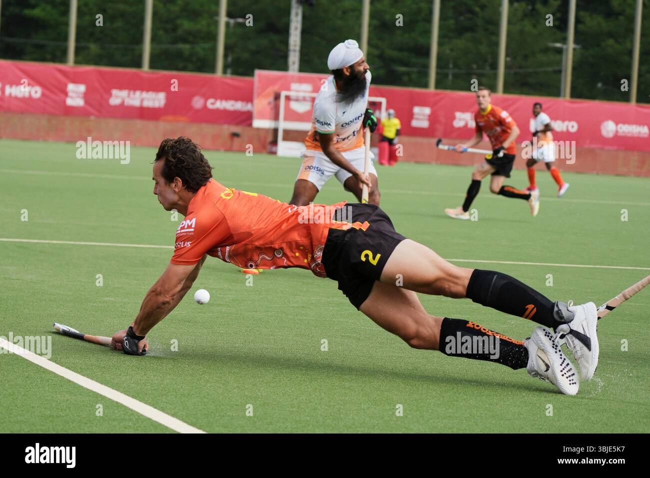 Australia's Tom Craig, left, falls as he chases the ball during the FIH ...