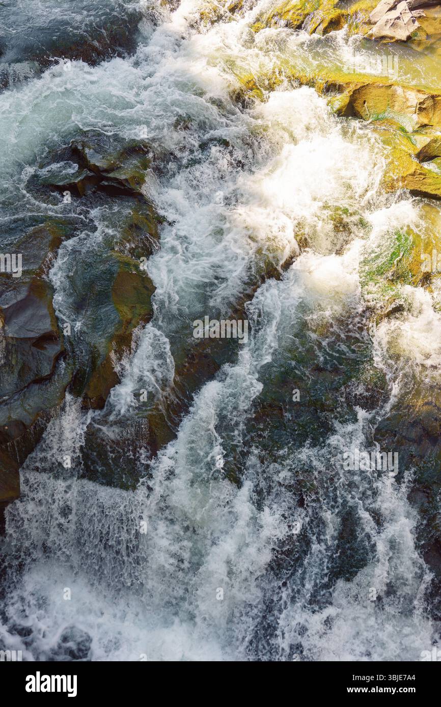 Dynamic image of a fast flowing mountain waterfall, rapid river ...