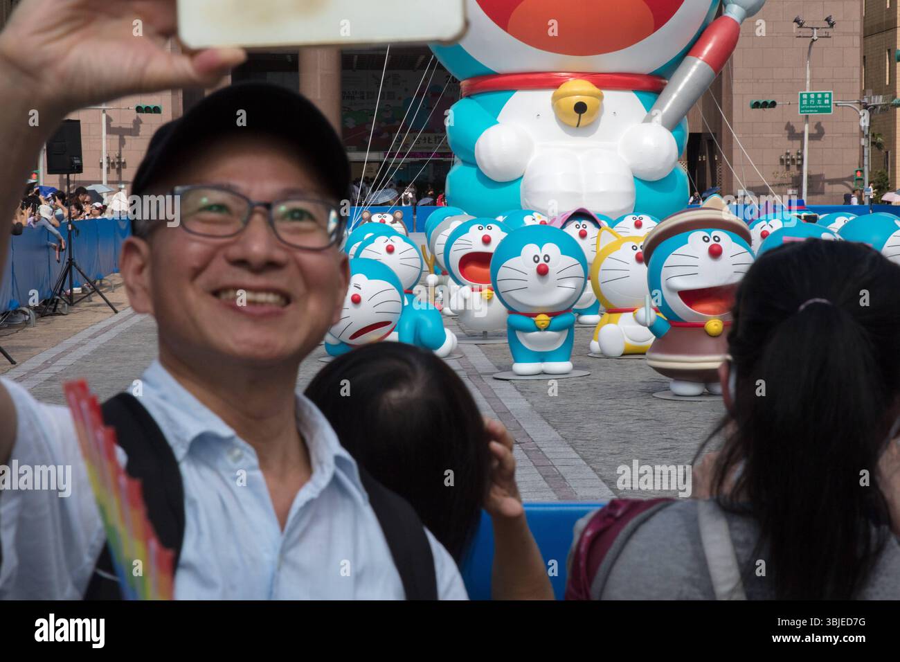People take pictures of Doraemon sculptures during Japanese manga ...