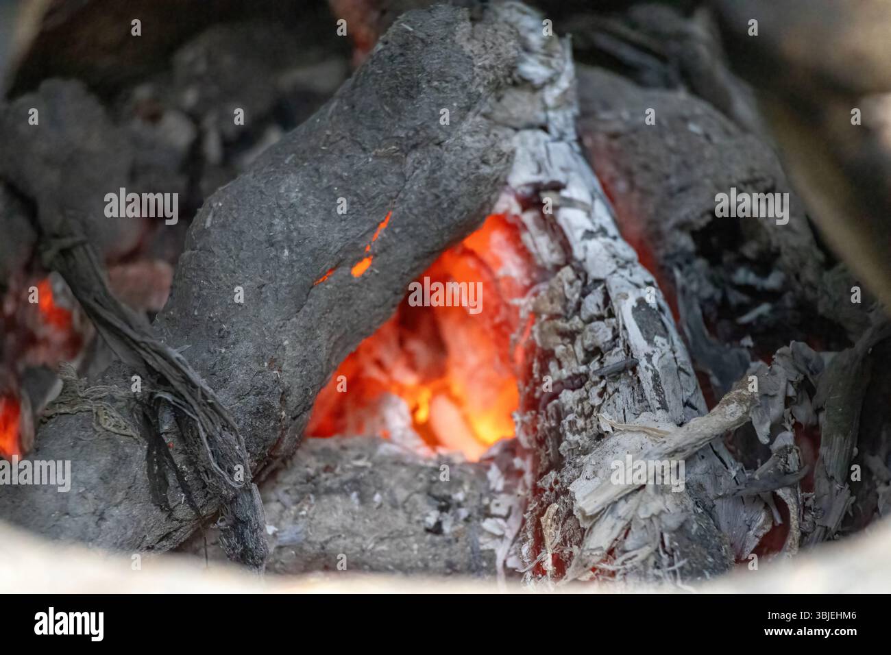 Burnt firewood coal and red hot embers in a clay stove after cooking ...