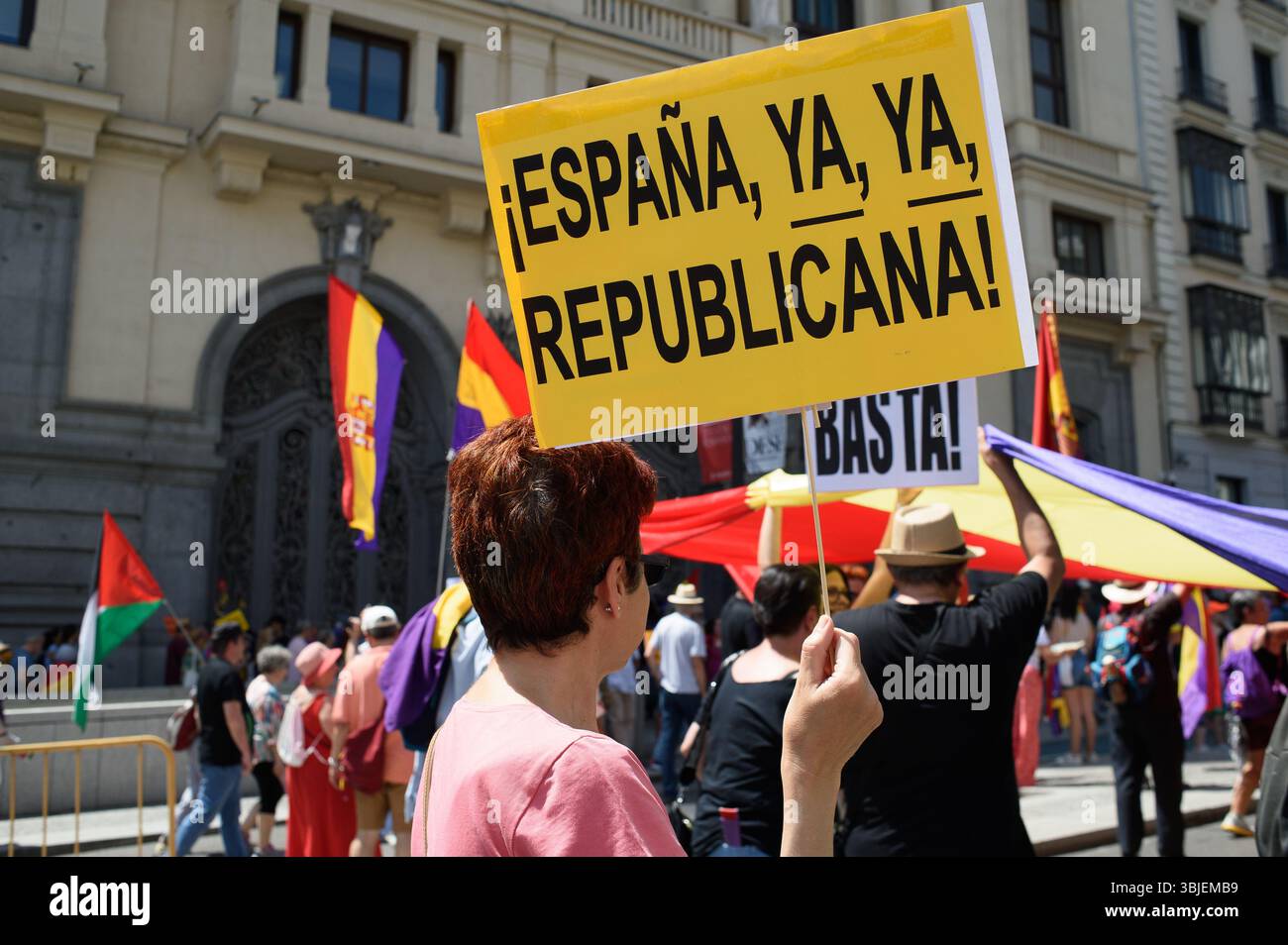 Madrid, Spain. 15th June, 2025. Protesters carry a banner and ...