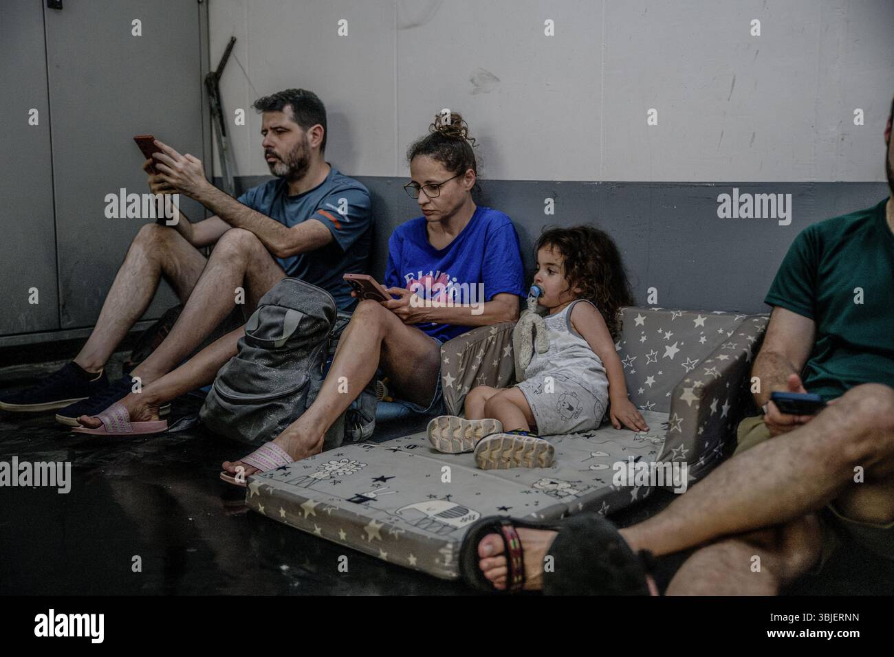 Israelis taking shelter in a public underground facility during an ...