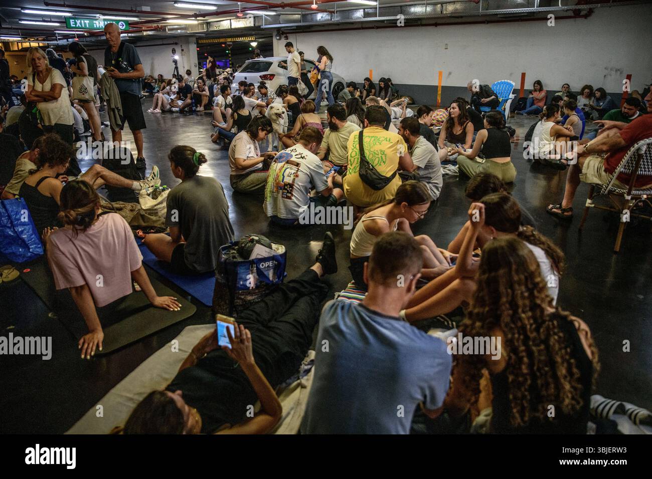 Israelis taking shelter in a public underground facility during an ...