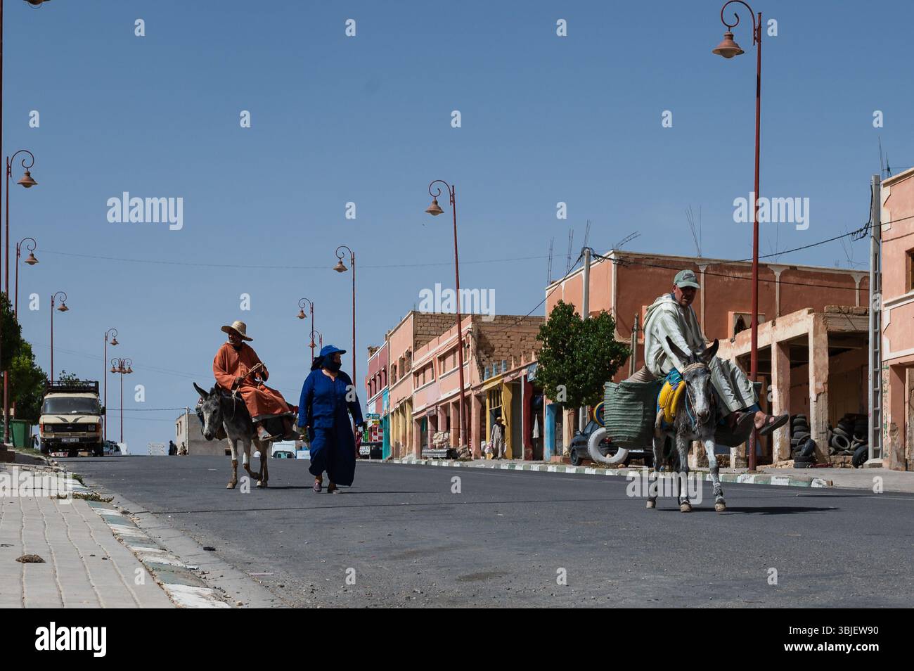 Berber people and donkeys in the street of a small town Stock Photo - Alamy