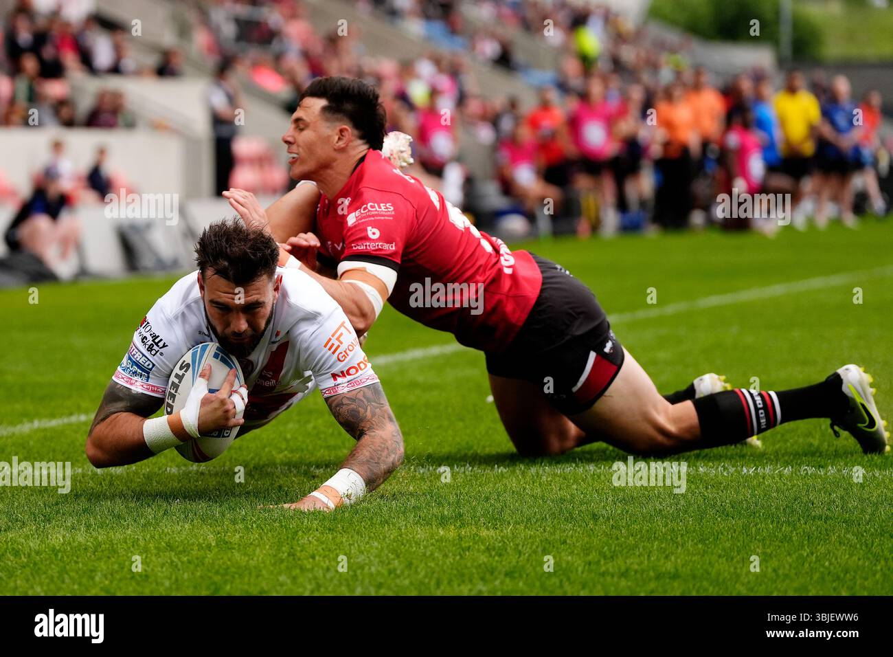 St Helens' Kyle Feldt (left) scores their side's second try of the game ...