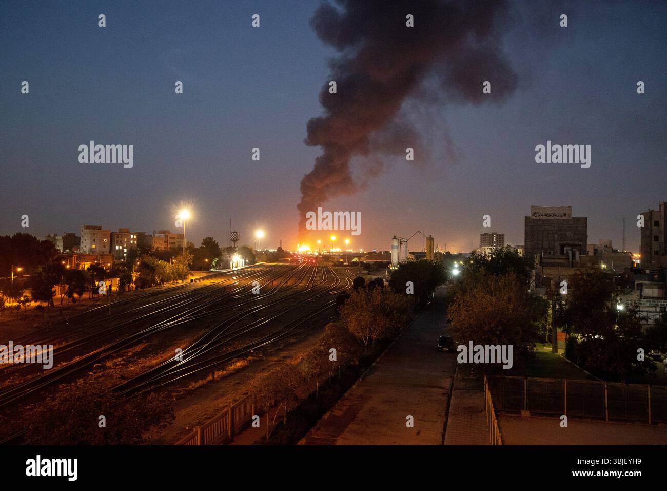Tehran, Iran. 15th June, 2025. Fire and smoke rise into the sky after ...