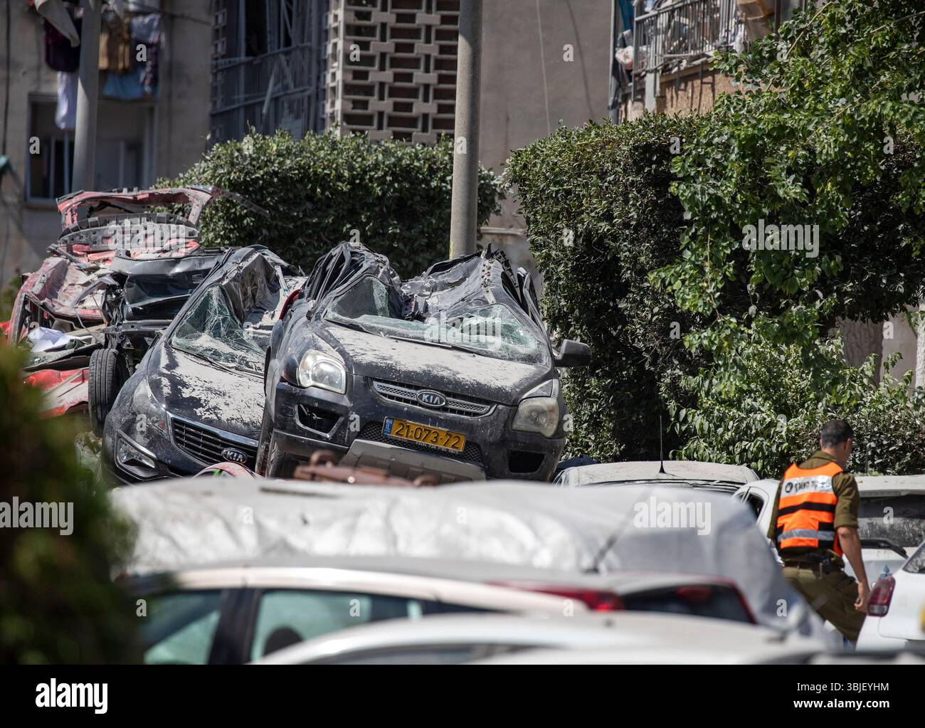Israeli cars one top of one another at the scene of an Iranian ...