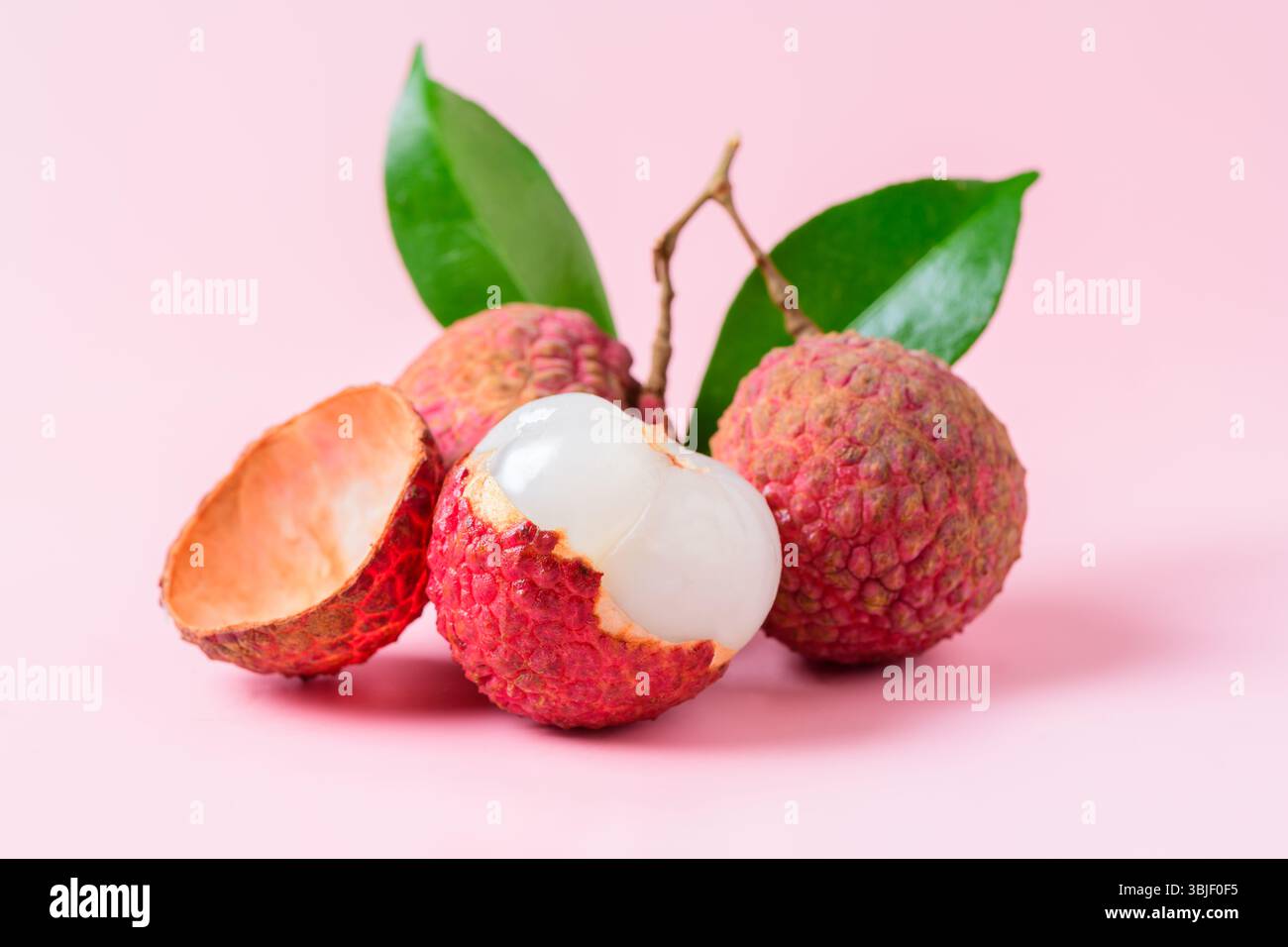 Juicy Lychee with cut in half and leaves isolated on pink background ...