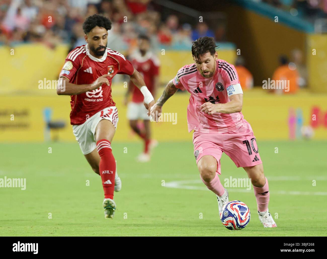 Marwan Attia of Al Ahly FC (13) and Inter Miami forward Lionel Messi ...