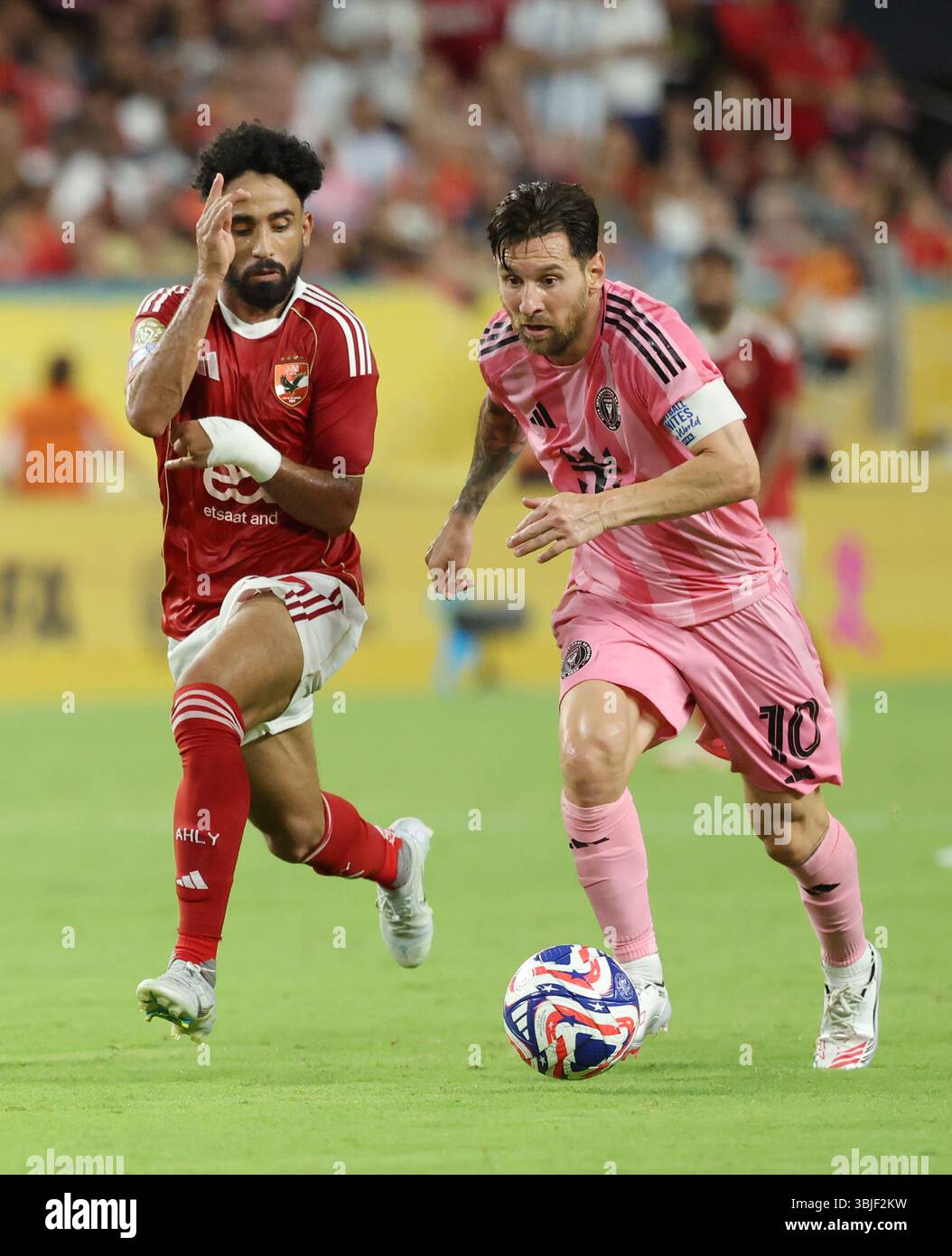 Marwan Attia of Al Ahly FC (13) and Inter Miami forward Lionel Messi ...