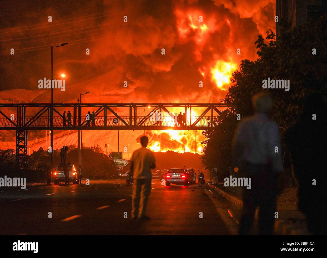 Tehran, Iran. 15th June, 2025. Iranians looking as a plume of heavy ...