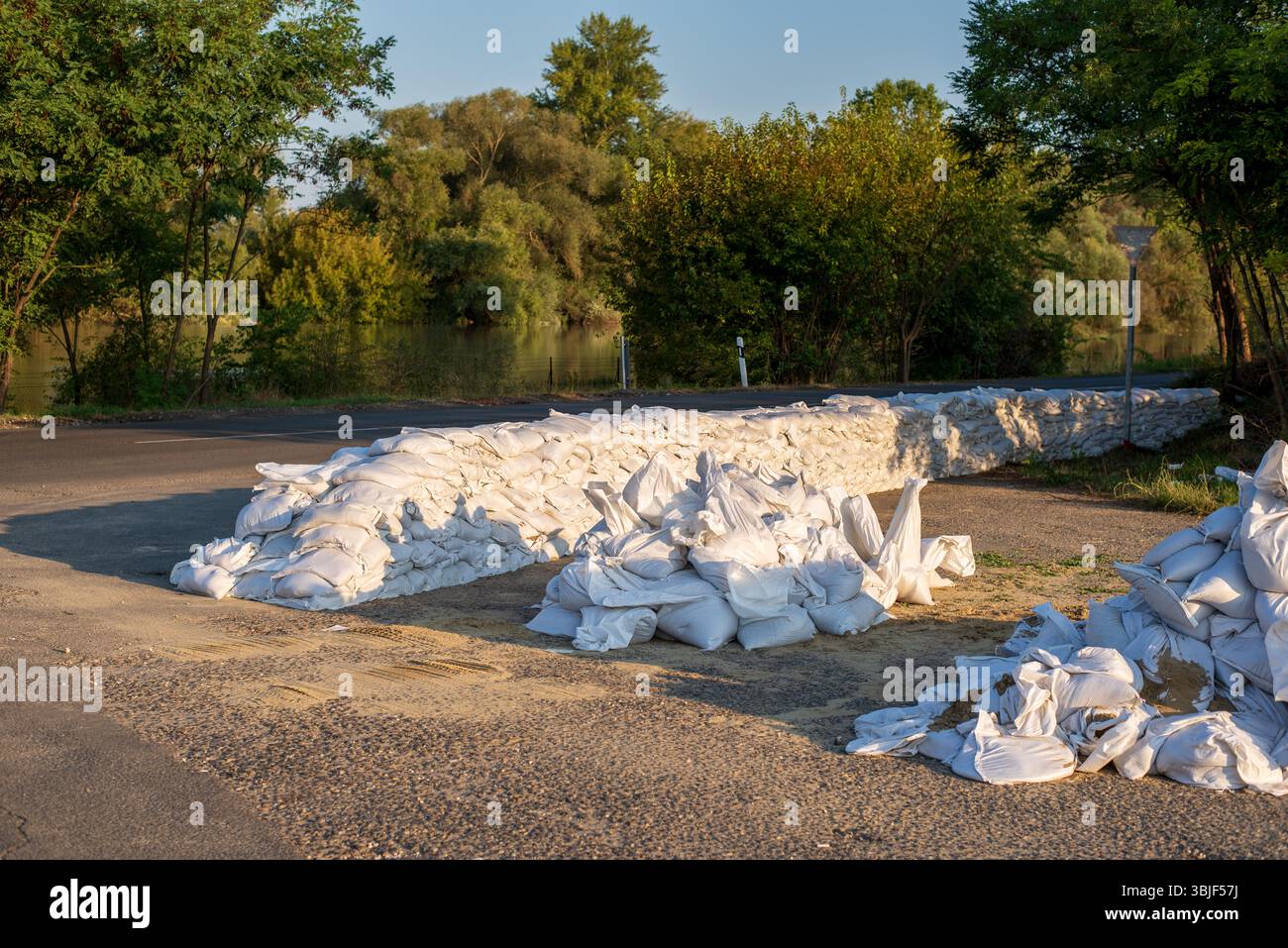 A sack is filled with sand to be used as a wall to prevent flooding in ...