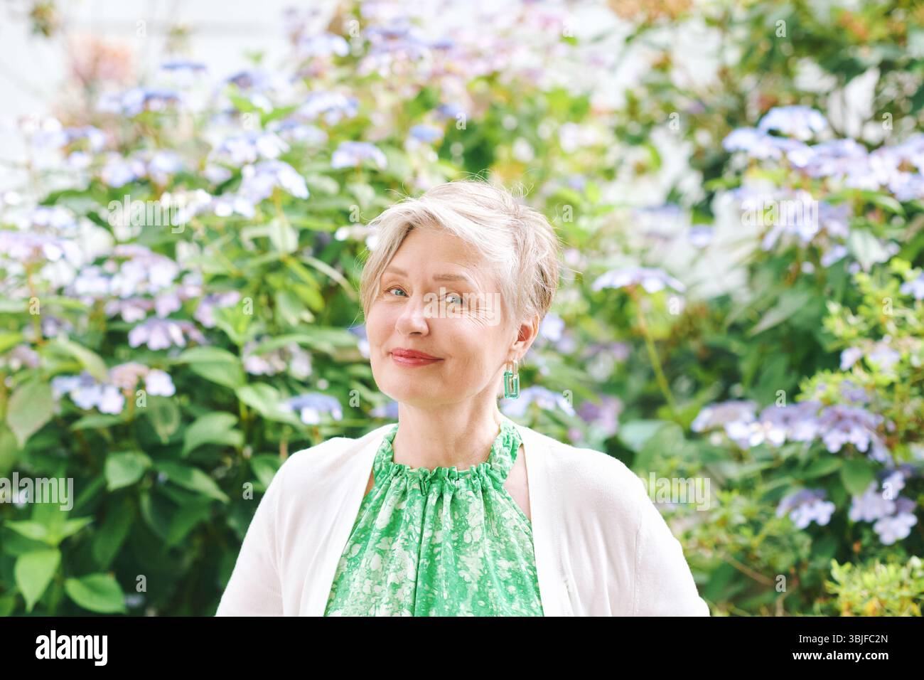Outdoor closeup portrait of beautiful mature woman of 55 - 60 year old ...