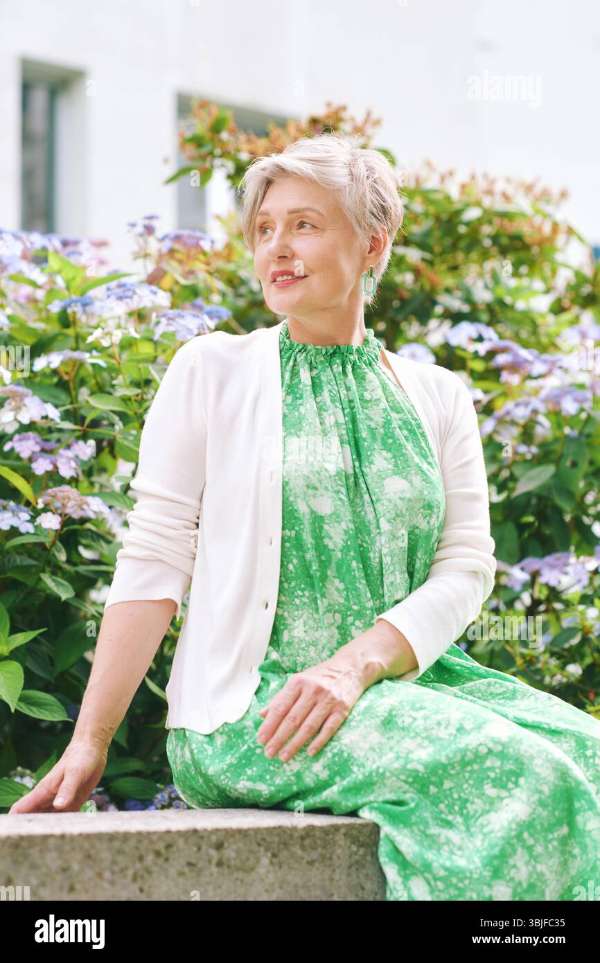 Outdoor portrait of beautiful mature woman of 55 - 60 year old, nice ...