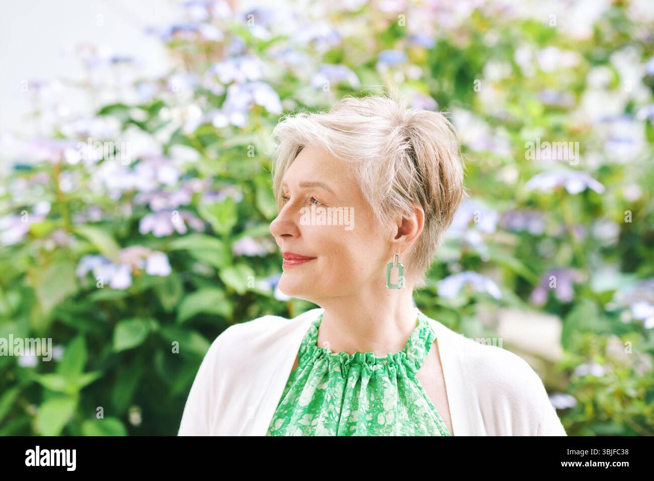 Outdoor closeup portrait of beautiful mature woman of 55 - 60 year old ...