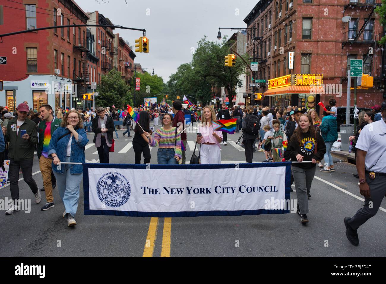 A New York City Council banner is carried down a city street during a ...