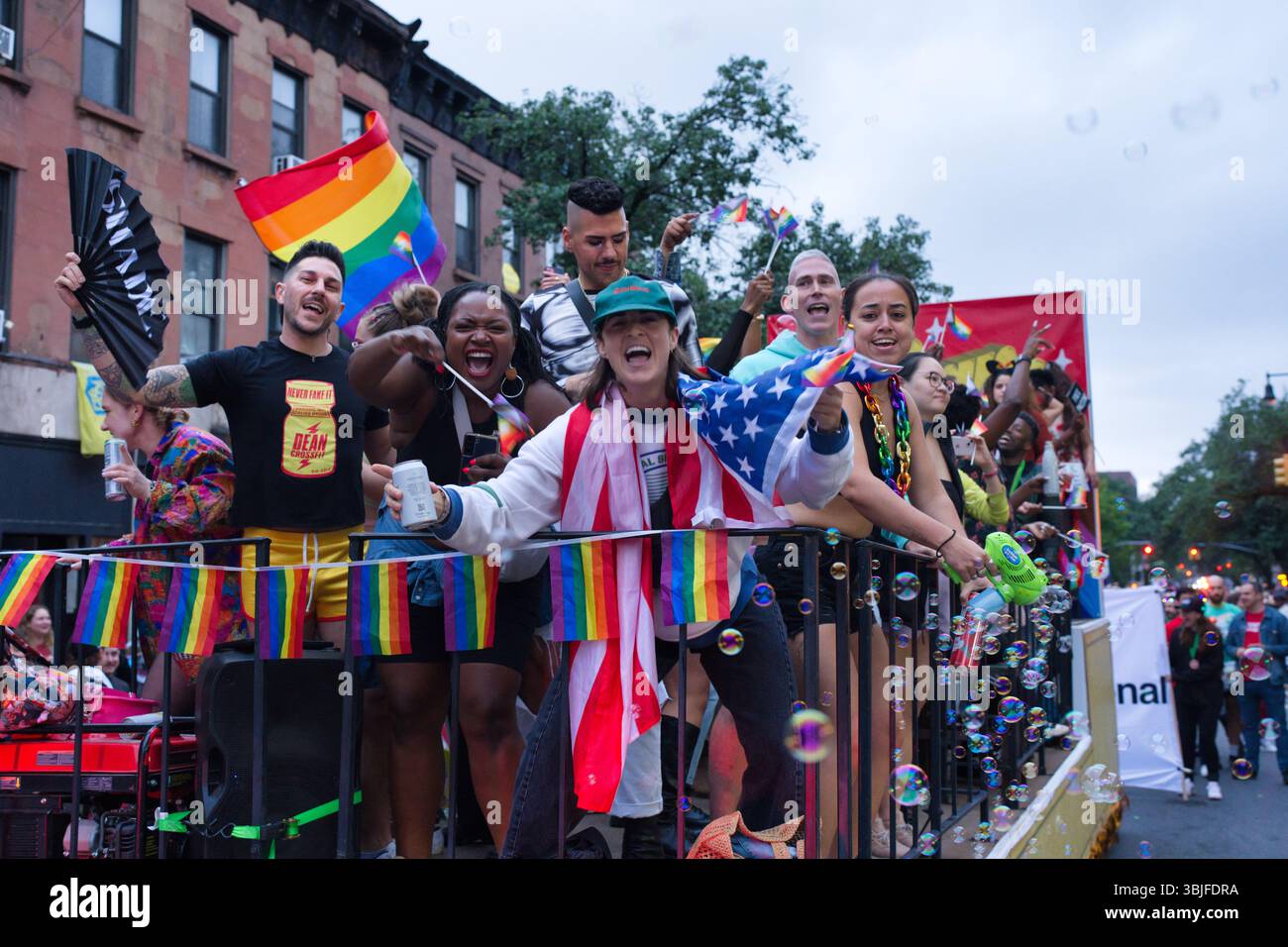 A vibrant Pride parade scene features a diverse group of people on a ...