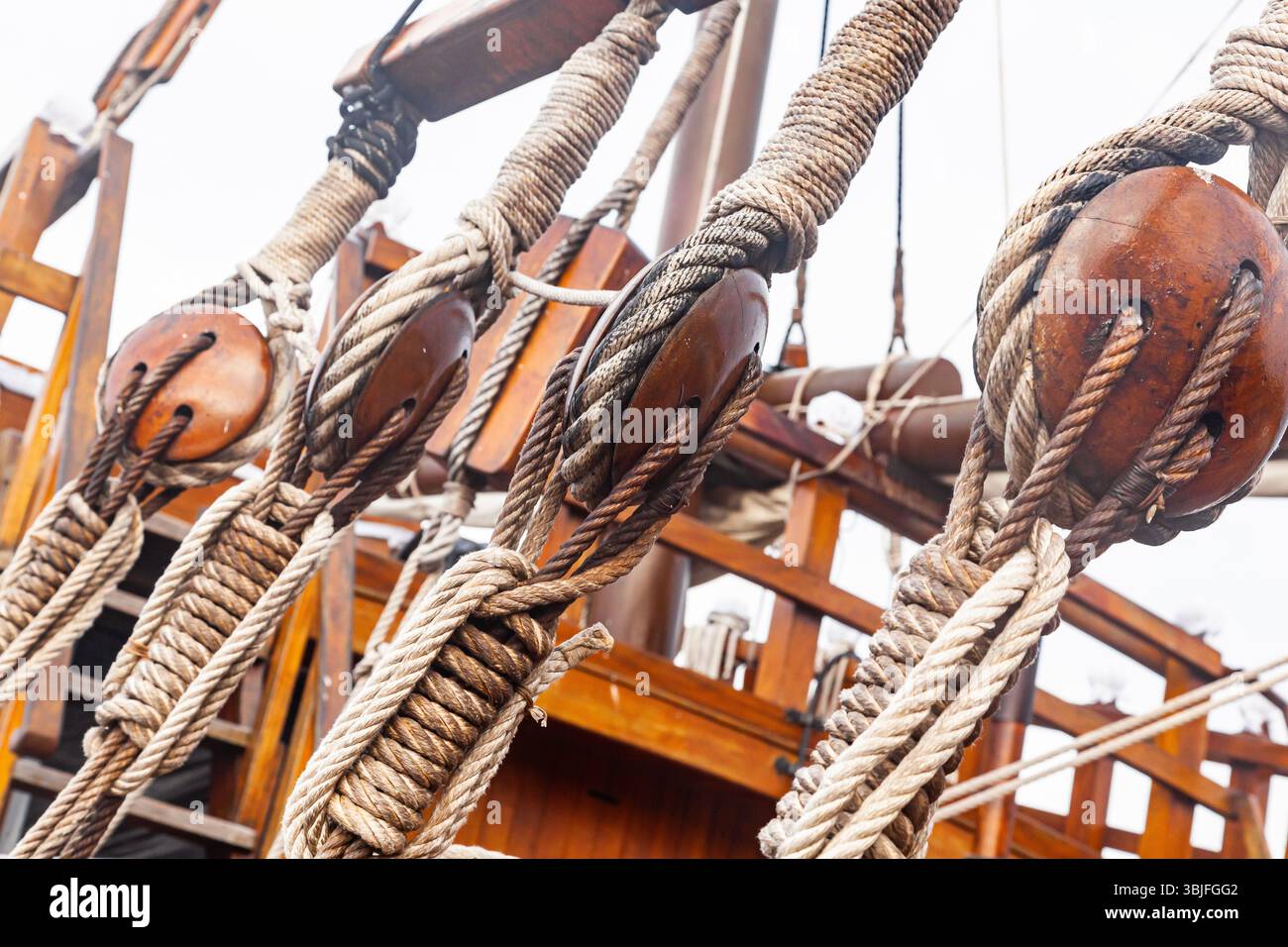 Traditional wooden sailing ship. Part of an old wooden ship with ropes ...