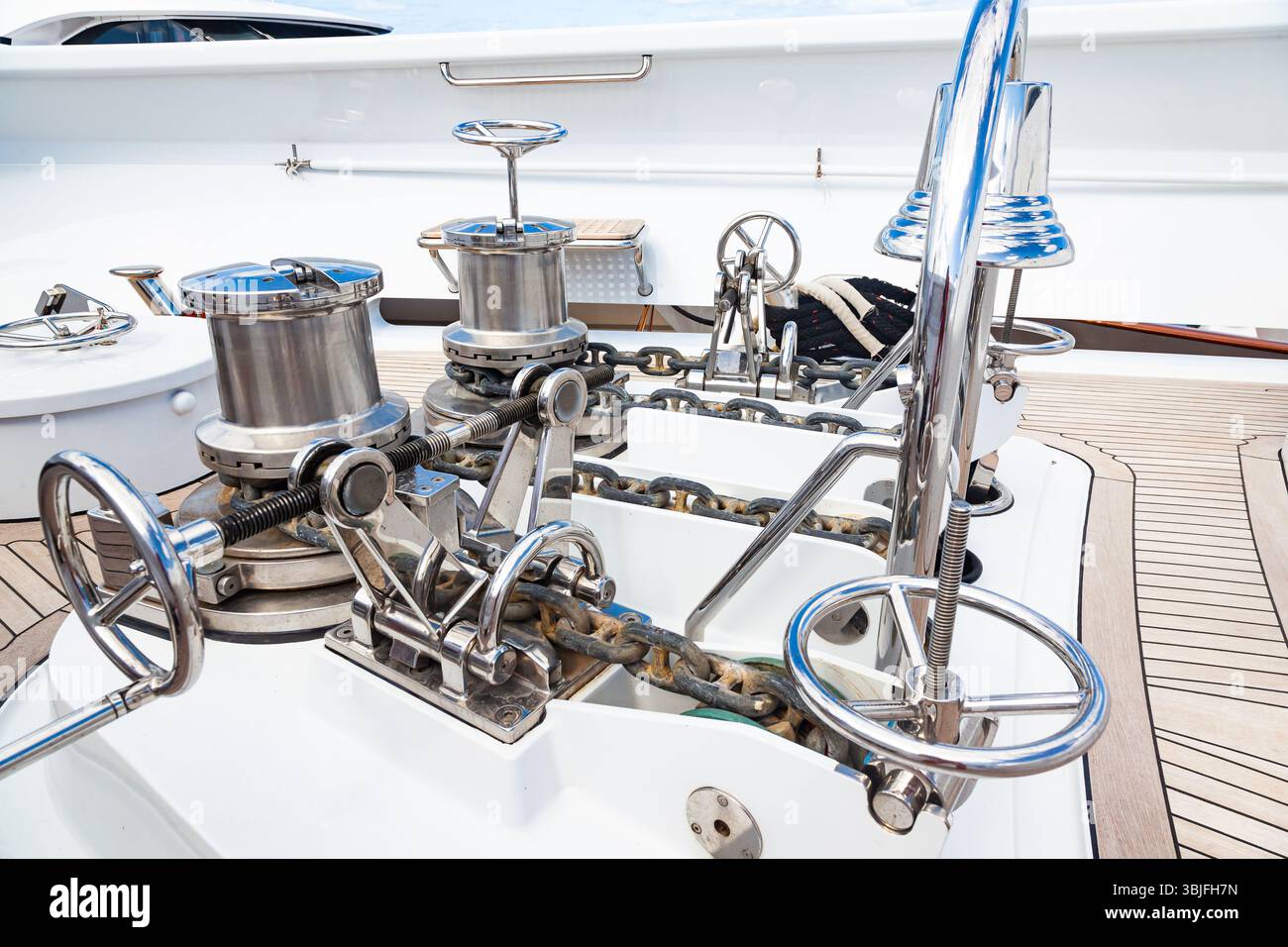 Bow part of the yacht with anchor stops, part of the anchor chain and ...