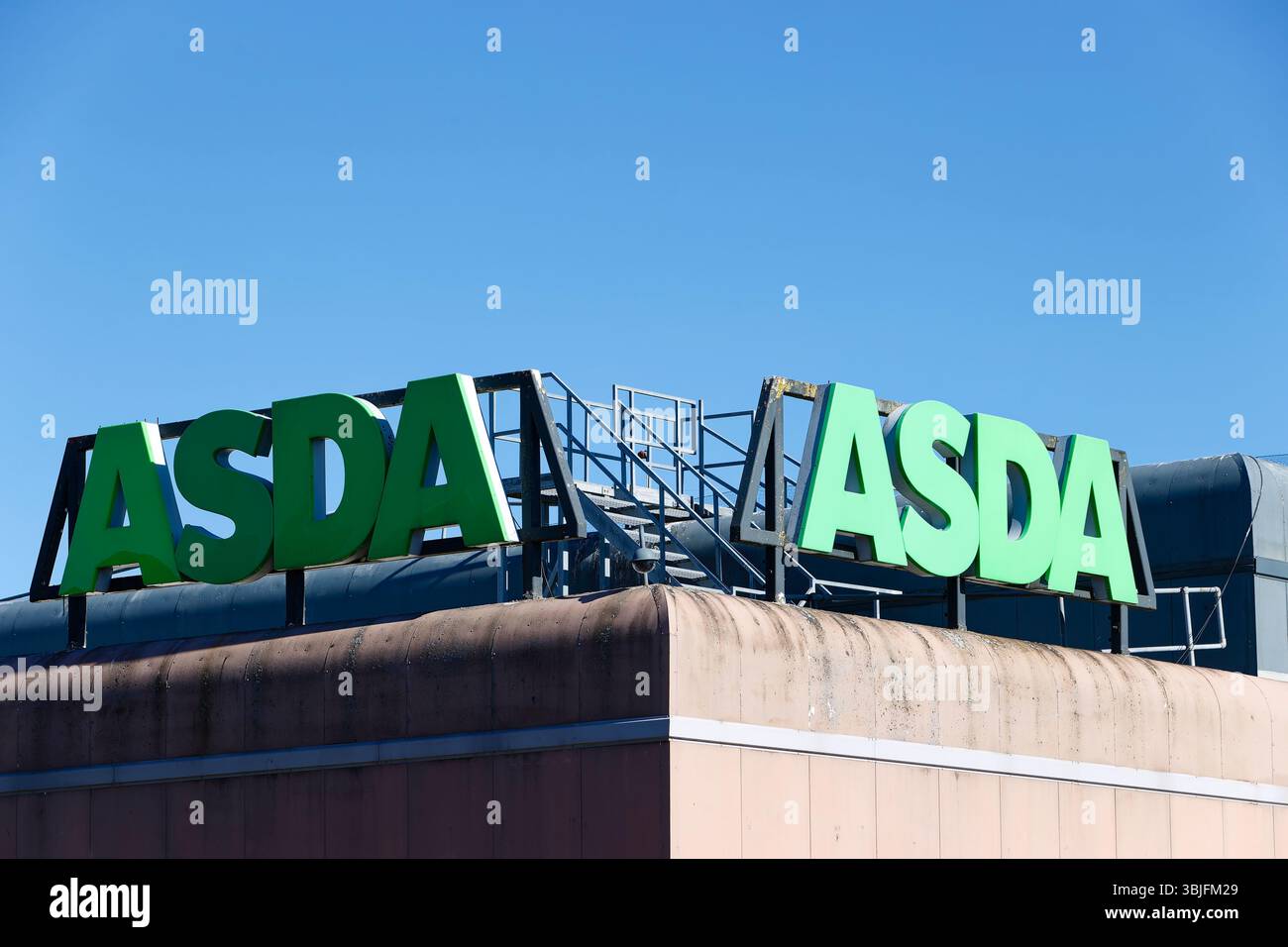 Asda sign on roof of supermarket with clear blue sky in bury lancashire ...