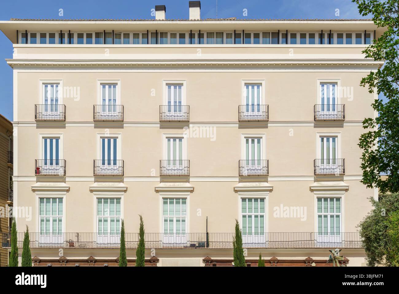 Elegant Beige Building with Balconies and Ornate Details Under Blue Sky ...