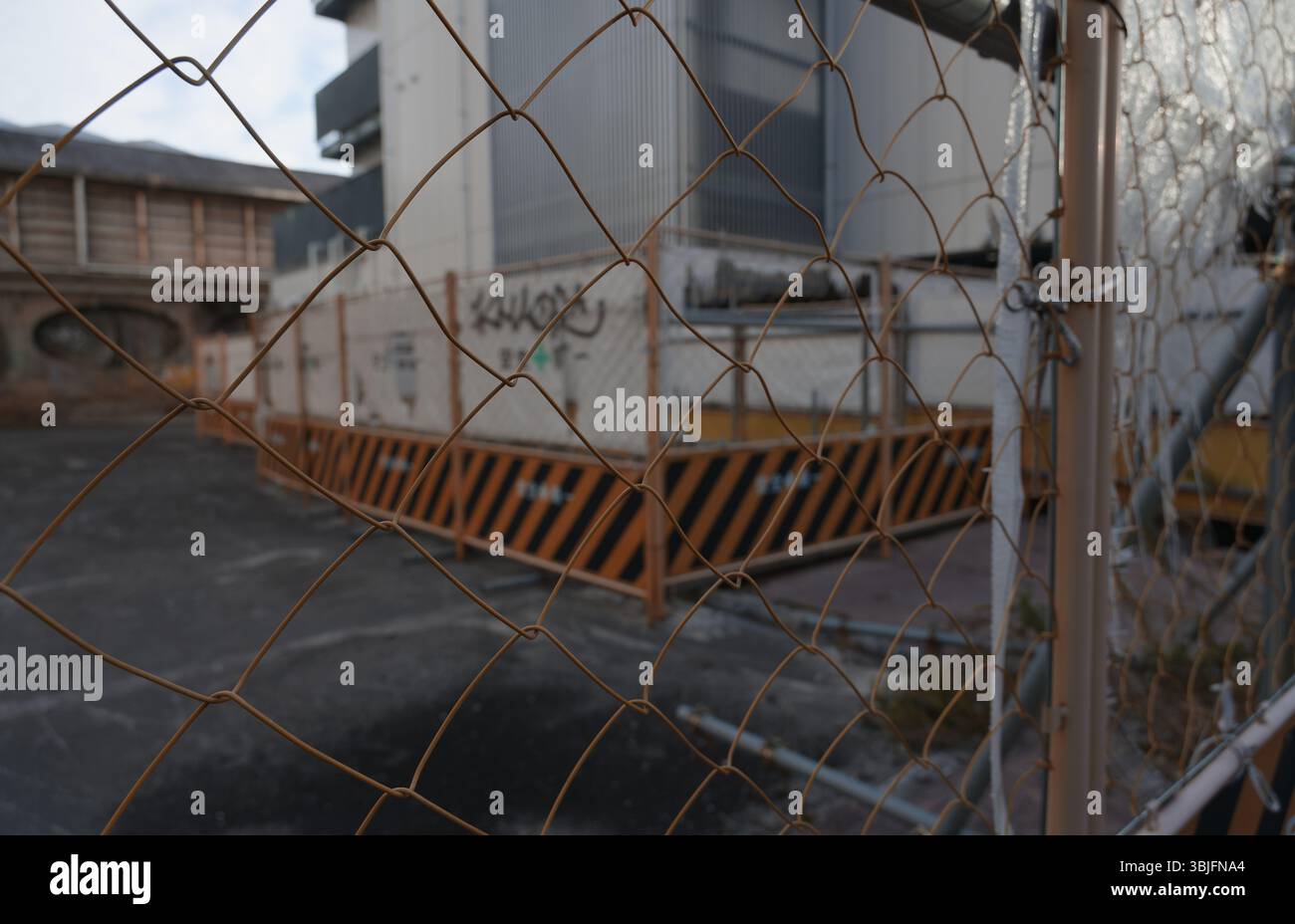 Construction site behind chain link fencing hi-res stock photography ...
