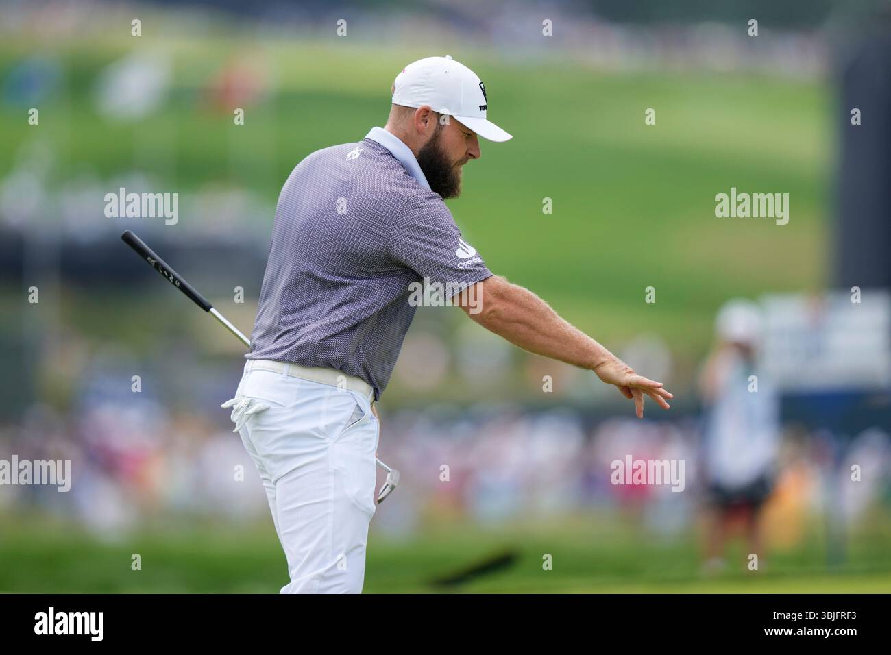 Tyrrell Hatton, of England, reacts after missing a putt on the fourth ...