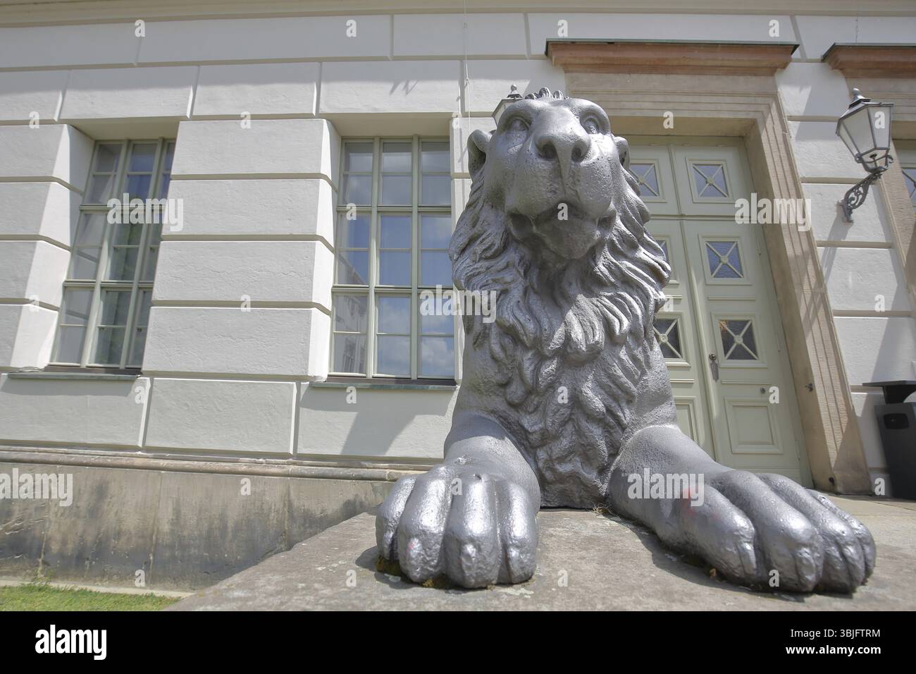 Head of lion figure with paws and entrance to historic lion building ...