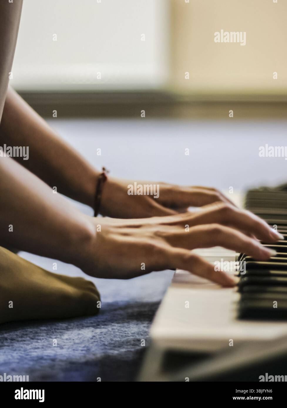 Hands playing the keys of the piano. hands playing the keys of the ...