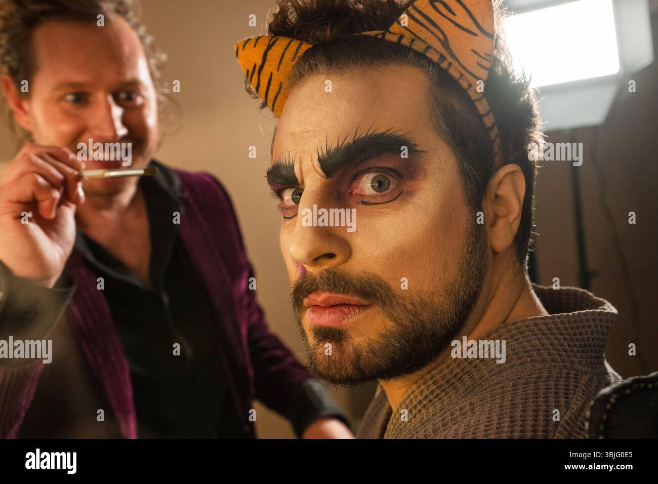 Justin Collette has his makeup applied by head of hair and makeup ...