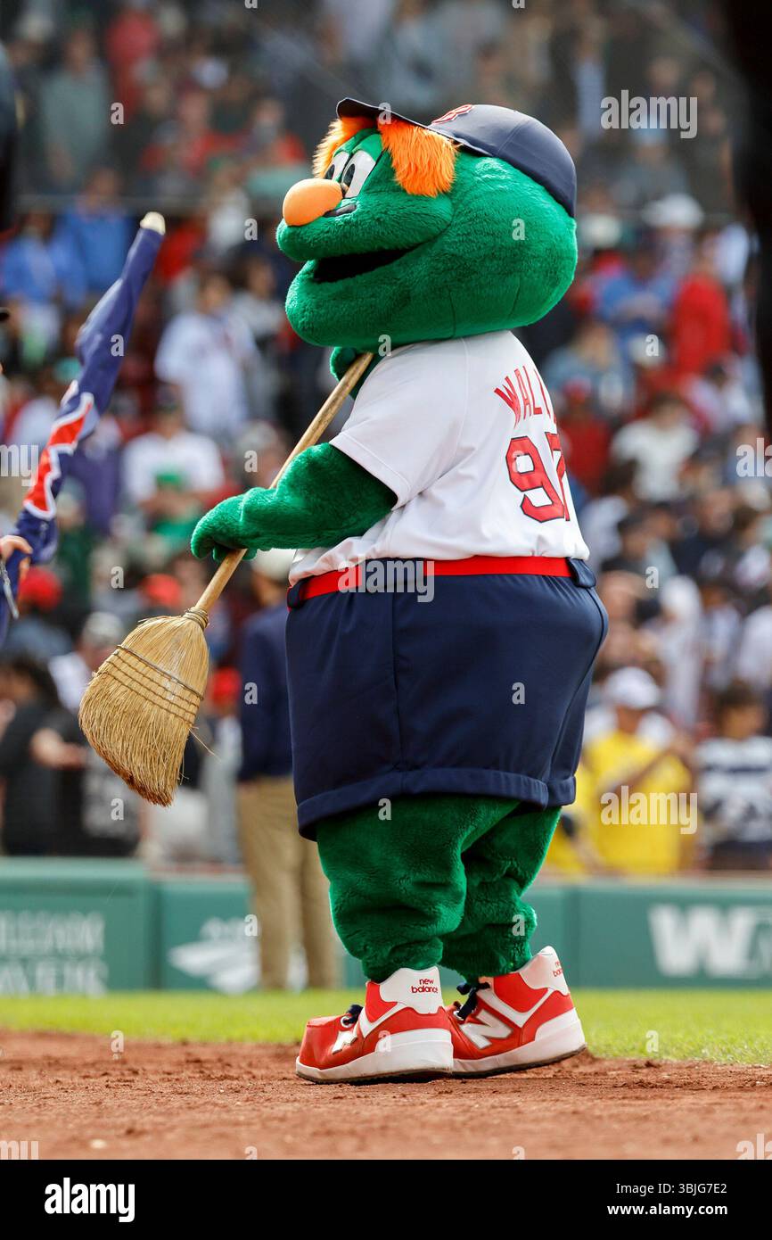 The Boston Red Sox mascot, Wally the Green Monster, holds a broom after ...