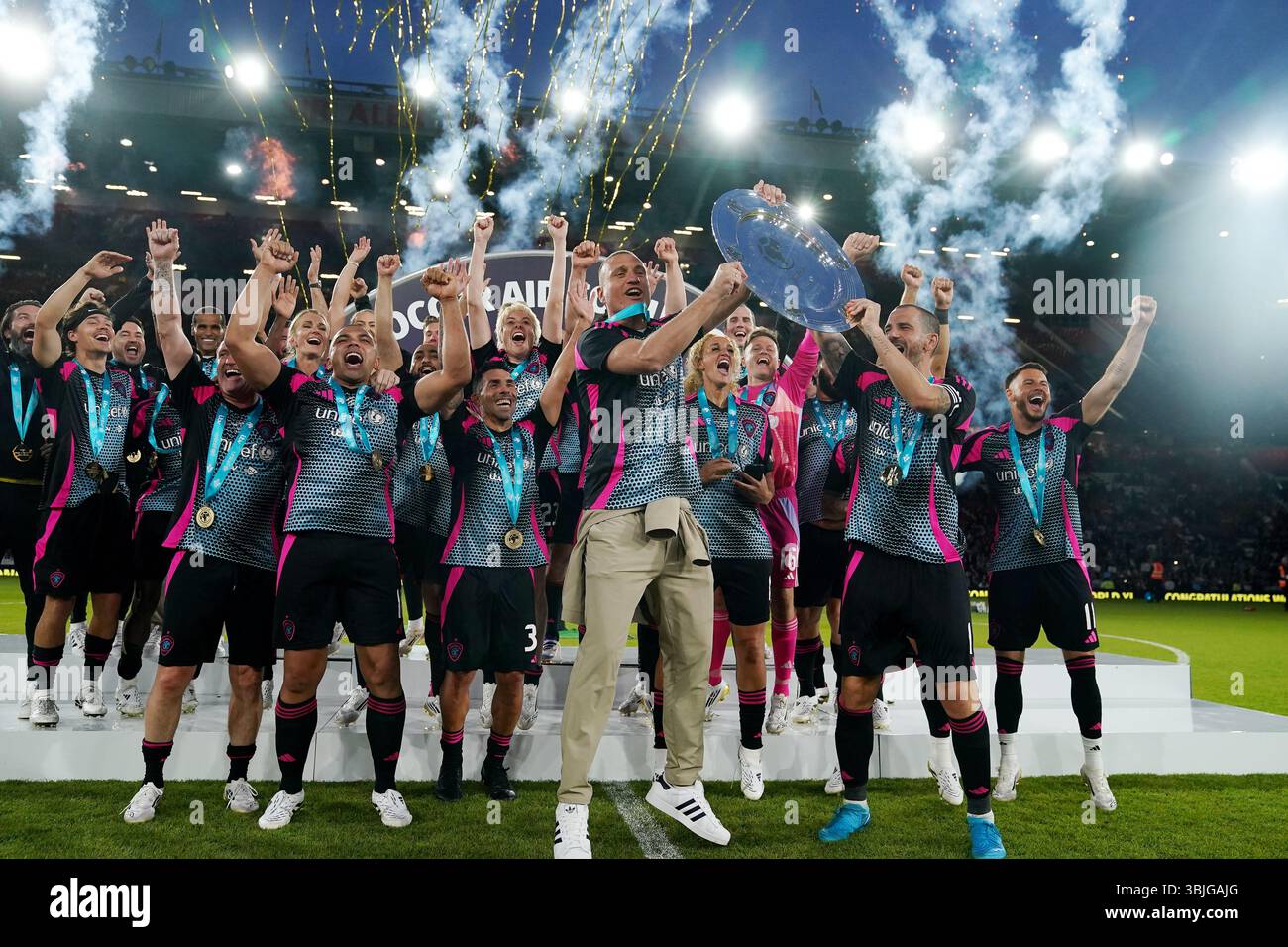 World XI's Leonardo Bonucci and Nemanja Vidic lift the trophy after ...