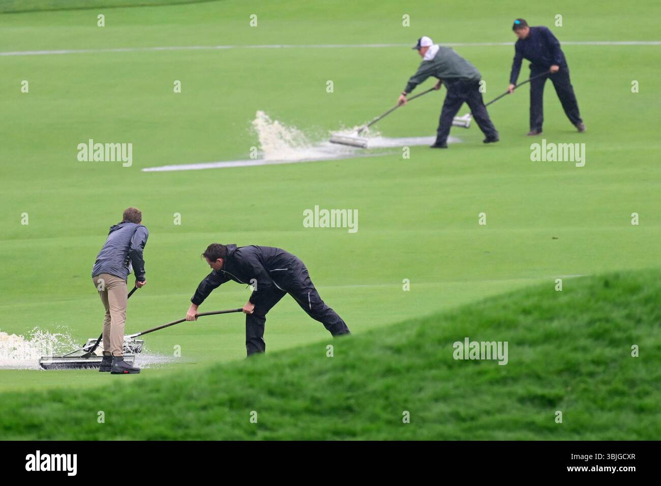 Pittsburgh, United States. 15th June, 2025. Groundkeepers use squeegees ...