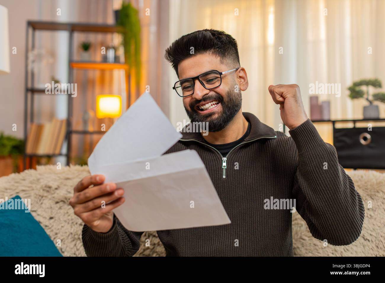 Indian man home opens envelope hi-res stock photography and images - Alamy