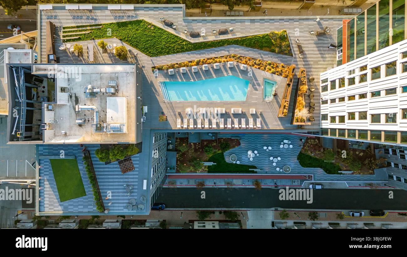 Aerial view of a rooftop pool and modern outdoor lounge area on a ...