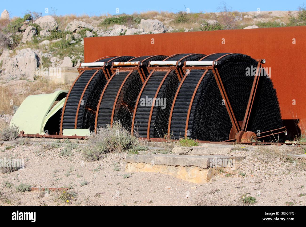 Large black biofilter wheels with metal frames are arranged in a row at ...
